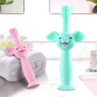 China Food Grade Silicone Baby Toothbrush Cartoon Pig Baby Teether Toy Soft Hair Oral Care Training Suction Base for sale