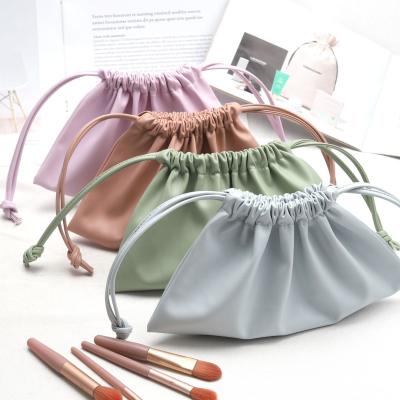 China Custom PU Leather Drawstring Cosmetic Bag 25x15cm Waterproof Emboss Logo for sale