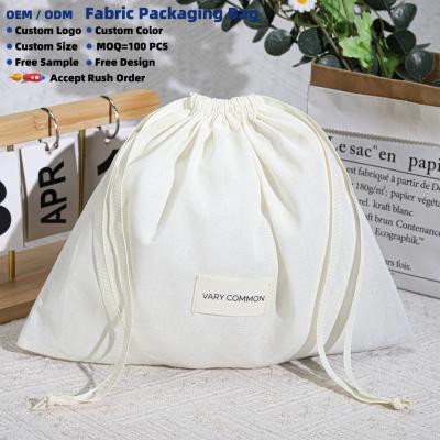 China Custom Organic Muslin Cotton Drawstring Dust Bag 20x30cm with Fabric Label for Cosmetic Underwear Storage for sale