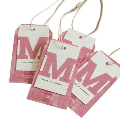 China Custom Luxury Garment Swing Tags 200-600gsm Paper Plastic Hang Tags With String For Clothing Branding for sale