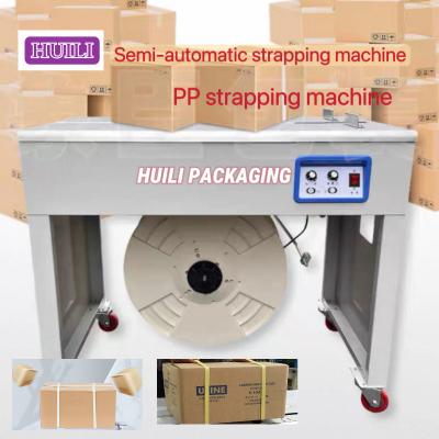 China Semi-automatic strapping machine 9-15mm PP strapping packaging equipment DC motor controlled for sale