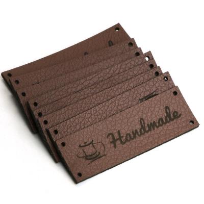 China Custom PU Leather Tag Labels with Text and Symbol for Clothing 50pcs MOQ for sale
