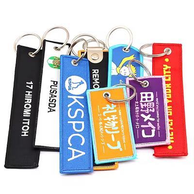 China Custom Embroidered Cotton Keychain 130x30mm Bulk Handmade Durable Fabric Key Ring for sale