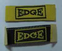 China Custom Heat Laser Cut Woven Patches Iron On Backing 50pcs Low MOQ Dry Cleanable for sale