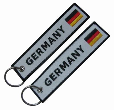 China Custom 12C Pantone Remove Before Flight Embroidery Keychain 130x30mm Merrow Border for sale
