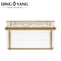 China High End Large Jewelry Display Case For Jewelry Store, Golden Hairline Stainless Steel And Ultra-Clear Tempered Glass for sale