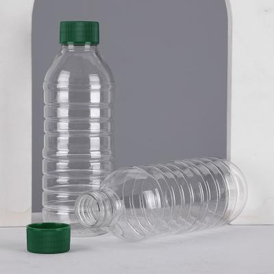 China Custom 300ml  Empty Transparent Round Juice PET Plastic Drinking Bottles Spring Water Beverage Container with Lids for sale