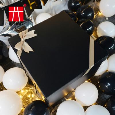 China Light Decorated Rectangular Boxes Garment Packaging Box With Tied Ribbon Bow for sale