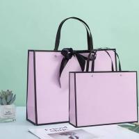 China Colorful Printed Paper Shopping Bag With Ribbon Handle Clothing Packaging for sale