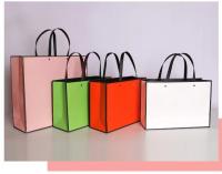 China Colorful Printed Paper Shopping Bag With Ribbon Handle Clothing Packaging for sale