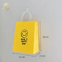 China 26cm Height Coated Yellow Paper Gift Bags Reusable With Smile Face for sale