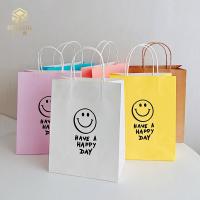 China 26cm Height Coated Yellow Paper Gift Bags Reusable With Smile Face for sale