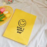 China 26cm Height Coated Yellow Paper Gift Bags Reusable With Smile Face for sale