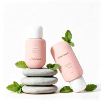 China Flat Unique 30ml Capacity Round Shape Sunscreen Bottle with Customized Printing for Cosmetic Use for sale