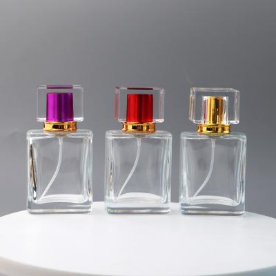 China 30ml 50ml Travel Rectangle Empty Perfume Glass Bottle with Aluminum Sprayer and Acrylic Cap SKIN CARE Crystal Spray Bottle for sale