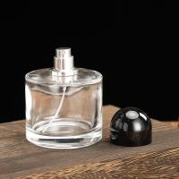 China 30ml 50ml 100ml Round Glass Perfume Bottles with Stock Fragrance Pump Spray and Empty Oil Packaging for sale