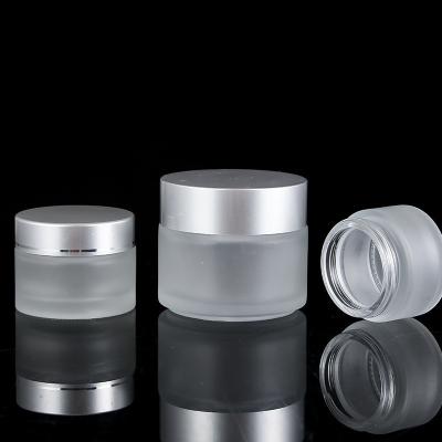China 15g 30g 50g 100g Frosted Clear Glass Cream Jar with Gold Silver Screw Lid Customized Logo and Frosted Glass Base Material for sale