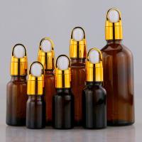 China Customized Accepted Essential Oil Small Round Empty Shiny Silver Gold Dropper Oil Bottle with Unique Flower Basket Rubber for sale