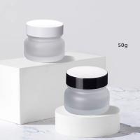 China Stock Luxury Skin Care Glass Jar 50g Empty Frosted Cosmetic Packaging with Black Lid and Glass Bottle Plastic Cap White Disc for sale