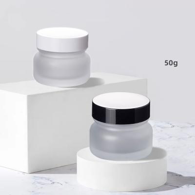China Stock Luxury Skin Care Glass Jar 50g Empty Frosted Cosmetic Packaging with Black Lid and Glass Bottle Plastic Cap White Disc for sale