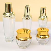 China Printing Handling Decoration Firing 100ml Glass Spray Bottle for Body Oil Economical Custom Logo Design Golden Glass Bottles for sale