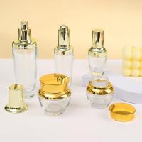China Printing Handling Decoration Firing 100ml Glass Spray Bottle for Body Oil Economical Custom Logo Design Golden Glass Bottles for sale