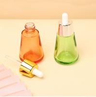 China Industrial Cosmetic Elegant 30ml 50ml 1oz 2oz Green Empty Oil Serum Dropper Bottles with Box Customize Unique Cone Shape for sale