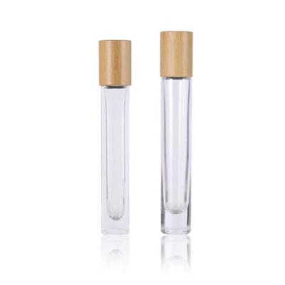 China Bamboo Essential Oil Roller Bottles 10ml 30ml 50ml Transparent Glass with Wooden Cap for sale