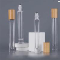 China Bamboo Essential Oil Roller Bottles 10ml 30ml 50ml Transparent Glass with Wooden Cap for sale