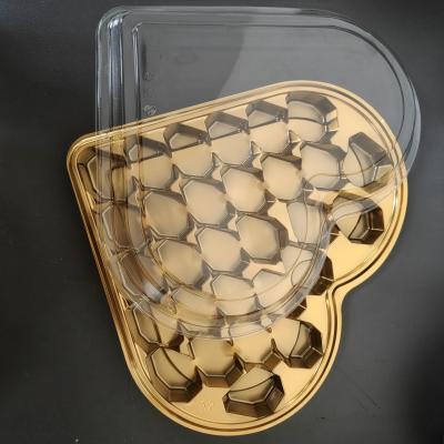 China Customized 28 compartment heart-shaped chocolate container with transparent lid plastic black/gold Pet inner tray for chocolate and fruit for sale