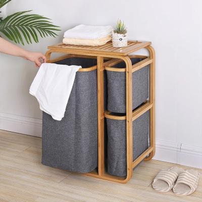 China Dual-Tier Bamboo Laundry Hamper with Removable 3-Section Sliding Basket Sorter Organizer for Cleaning Clothing for Bathrooms for sale