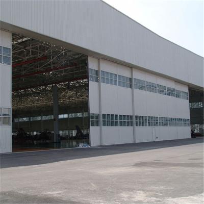 China Horizontal Steel Bottom Rolling Hangar Door Multi Panel Sliding System Remote Controlled for sale