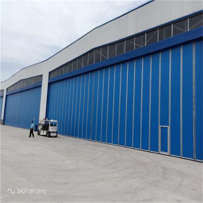 China Heavy Duty Vertical Design Fold Up Hangar Doors Space Saving For Industrial Facilities for sale
