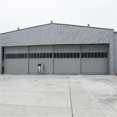 China Hydraulic Powered Swing Hangar Door Heavy Duty Steel Pivot Style Door System for sale