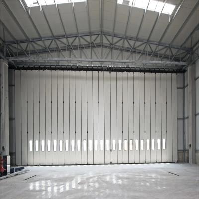 China Windproof Large Span Folding Hangar Door Corrosion Resistant Industrial Bi Fold Door for sale