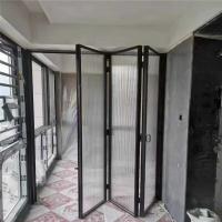 China Aluminum Frame Glass Bi Folding Industrial Doors Dustproof Energy Saving Custom Thickness for sale