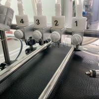 China Small 4 Head Liquid Filling Machines Electric With Conveyor Belt for sale