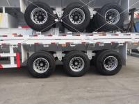 China 12R225 Tyre Flat Bed Semi Trailer 3 Axles Strong Frame Trailer Perfect for Transporting Oversized Equipment and Materials for sale
