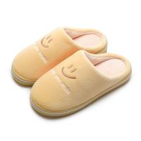 China Hot selling 2021 new fashion soft plush winter slippers smile patterns vamp non-slip couple home shoes in stock for sale