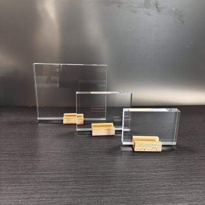 China Transparent Block Acrylic Stand With Wooden Base UV Printed And Customizable Size For Elegant Desktop Decor for sale