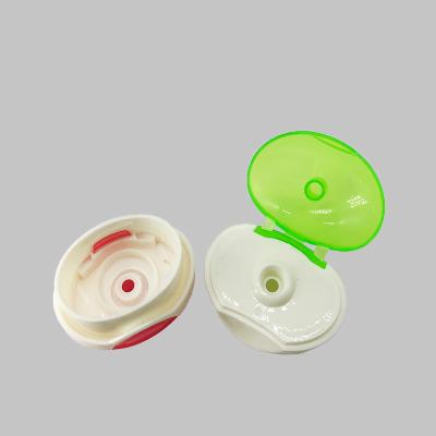 China Plastic PP 22mm Neck Size Oval Shape Double Color Flip Top Caps For Shampoo Bottles for sale