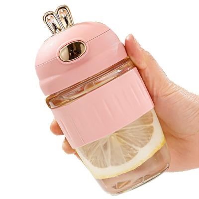China Glass Straw Cup 420ml with Silicone Sleeve Cute Bunny Rabbit Ear Design Reusable Water Bottle for sale