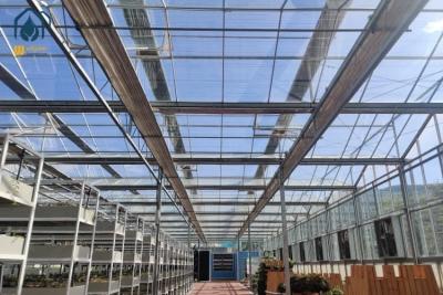 China Transparent Glass Greenhouse Customized Commercial Hydroponic Greenhouses With Motor Ventilation for sale