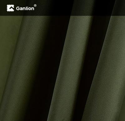 China Olive Green Polyester PBT Fabric Twill 2/1 Stretchable Pants Fabric for sale