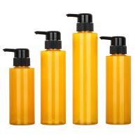 China Customized PET Round Lotion Pump Shampoo Bottle Cylinder Yellow color for sale