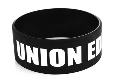 China Black 25mm Width Debossed And Fill In Custom Silicone Rubber Wristbands for sale