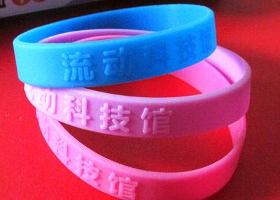 China Low Relief Custom Silicone Rubber Wristbands Embossed Logo Lettering Raised for sale