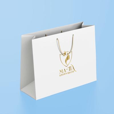 China Custom Kraft Paper Gift Bag with Ribbon Embossed Design for Boutique Retail Packaging for sale