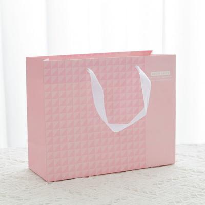 China Custom Kraft Paper Gift Bag with Ribbon Rope Handle for Clothing Shop Packaging 32x24x10cm for sale
