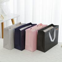 China Custom Pink 250G Kraft Paper Gift Bags with Three-Strand Rope Handles Matte Gold Logo for sale